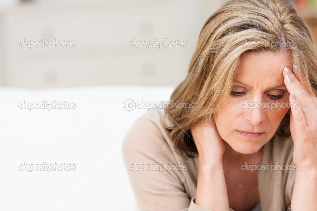 Woman suffering from stress grimacing in pain Woman suffering from stress grimacing in pain